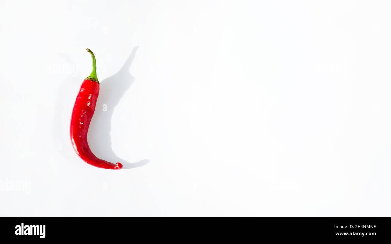 One red hot pepper and its shadow on a white background Stock Photo - Alamy