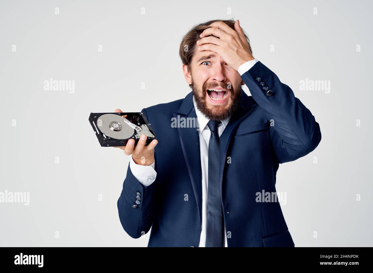 emotional business man with hard drive on computer technology Stock ...