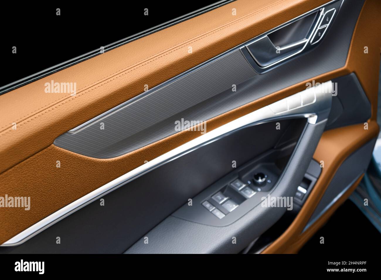Car door handle inside the luxury modern car with brown leather texture ...