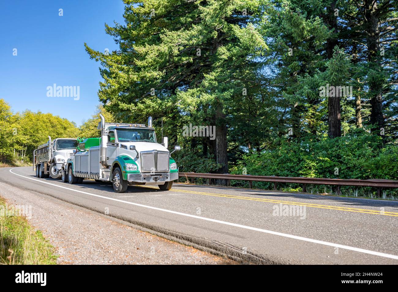 Green and white powerful mobile road assistant big rig towing semi ...