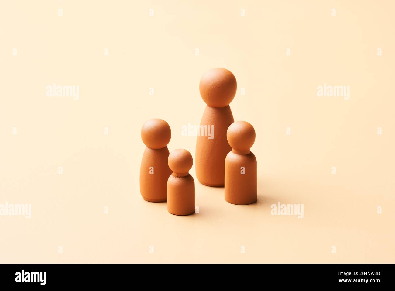 Simple wooden figurine of ethnic woman and kids representing single ...