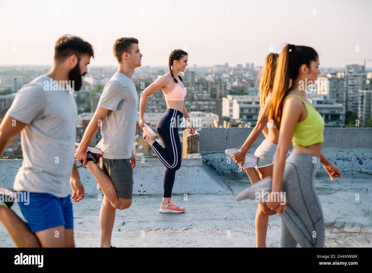 Group of happy fit people friends exercising together outdoor Stock ...