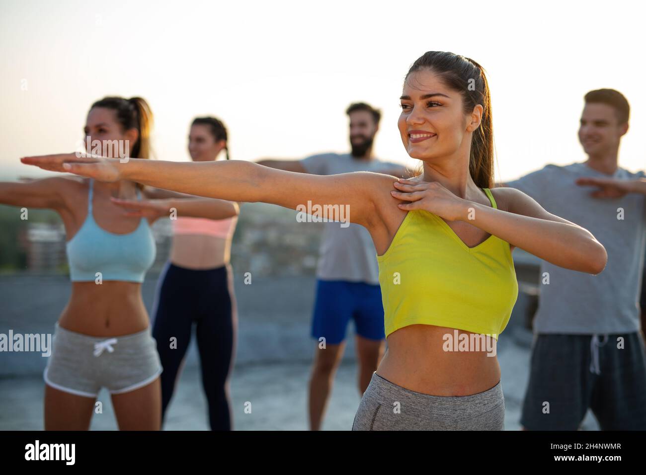 Group of happy fit people friends exercising together outdoor Stock ...