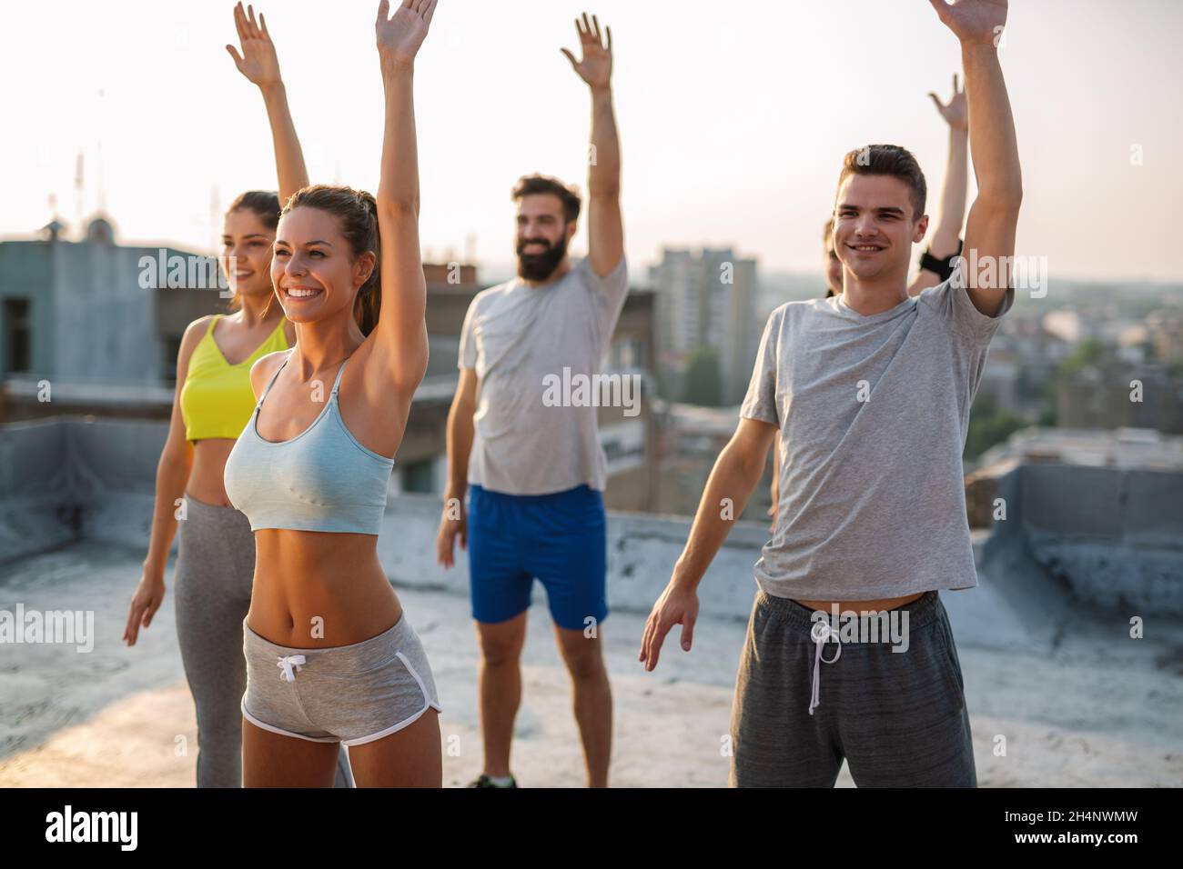Group of happy fit friends exercising together outdoor Stock Photo - Alamy