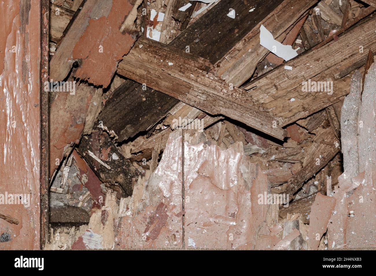 A hole in the old wooden floor. Rotten, broken boards. View from above ...