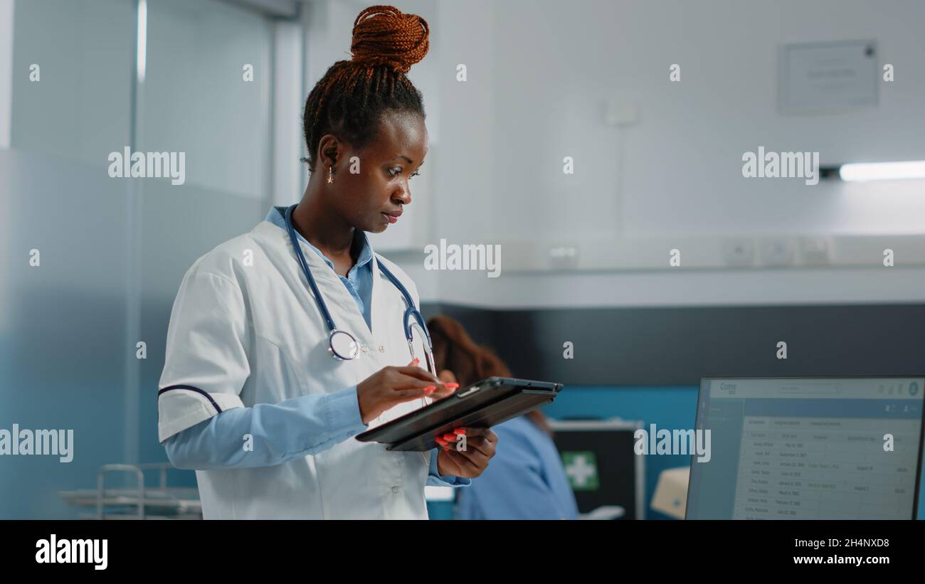 Medic looking at tablet screen for healthcare system in cabinet. Doctor ...