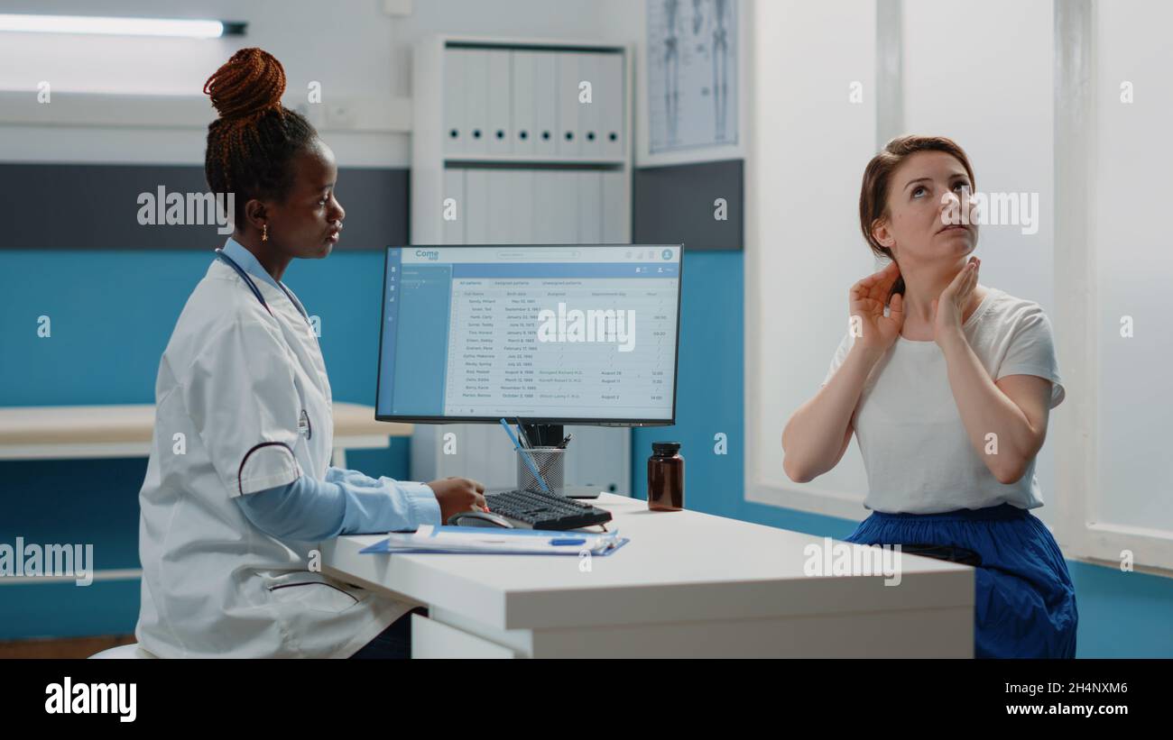 Doctor listening to patient with neck pain and sickness for diagnosis ...