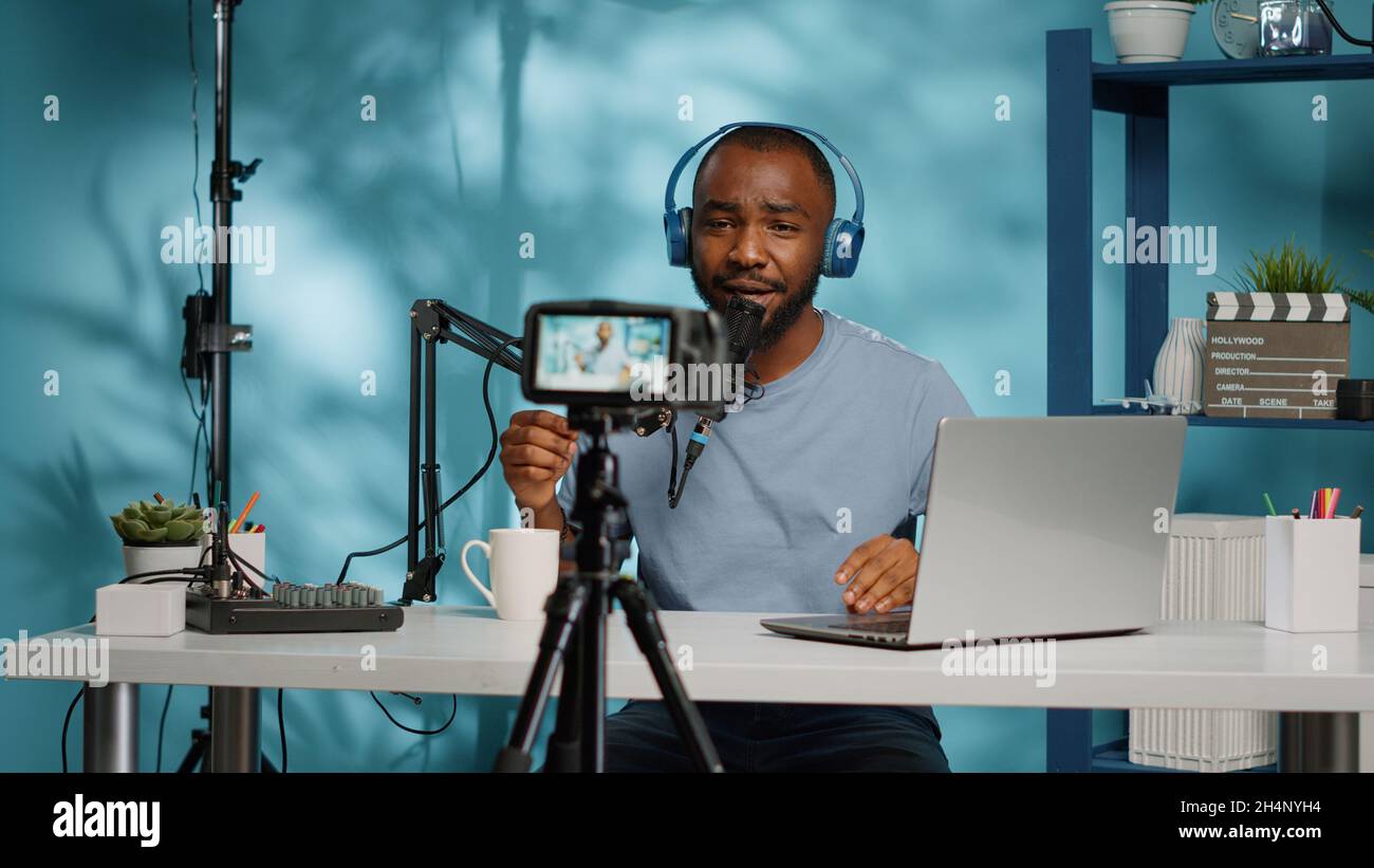 African american vlogger using camera to record video in studio while ...