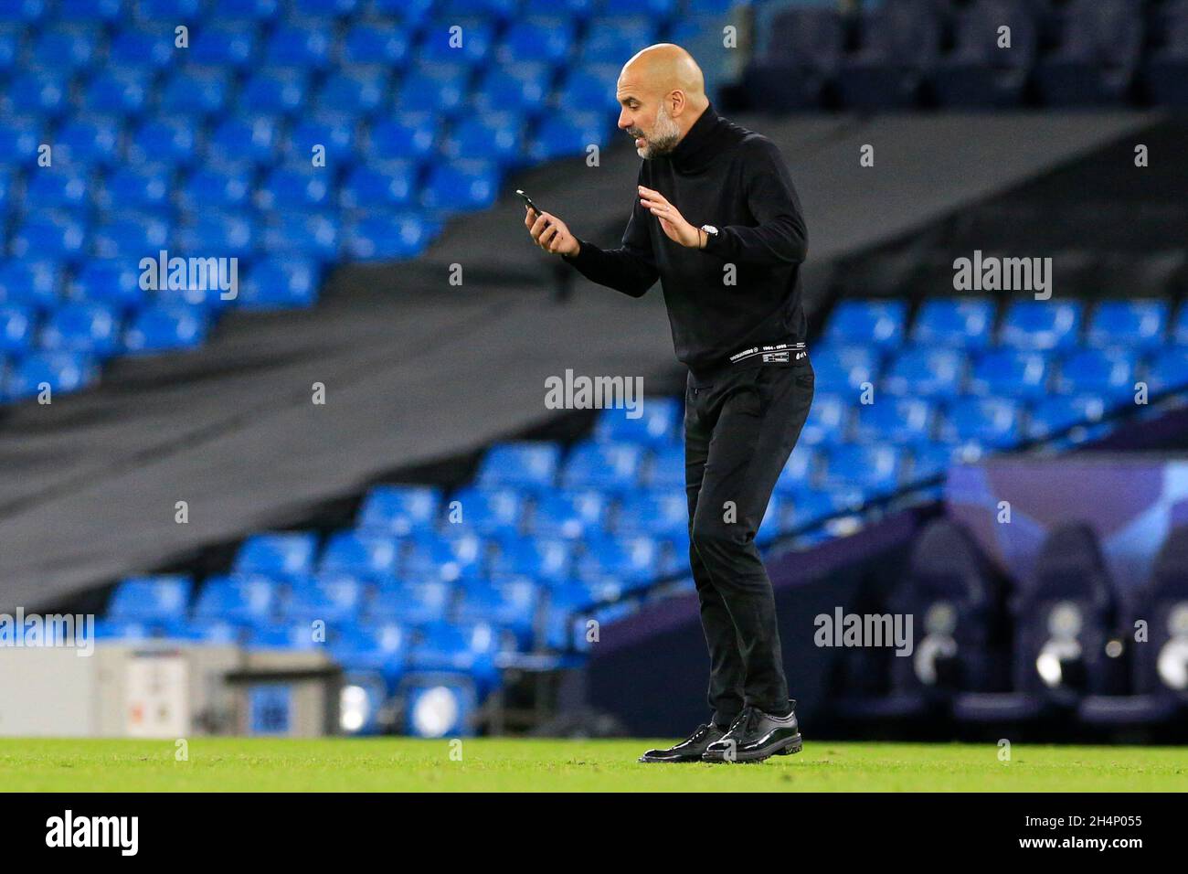 Pep Guardiola the Manchester City manager on his phone at the end of ...