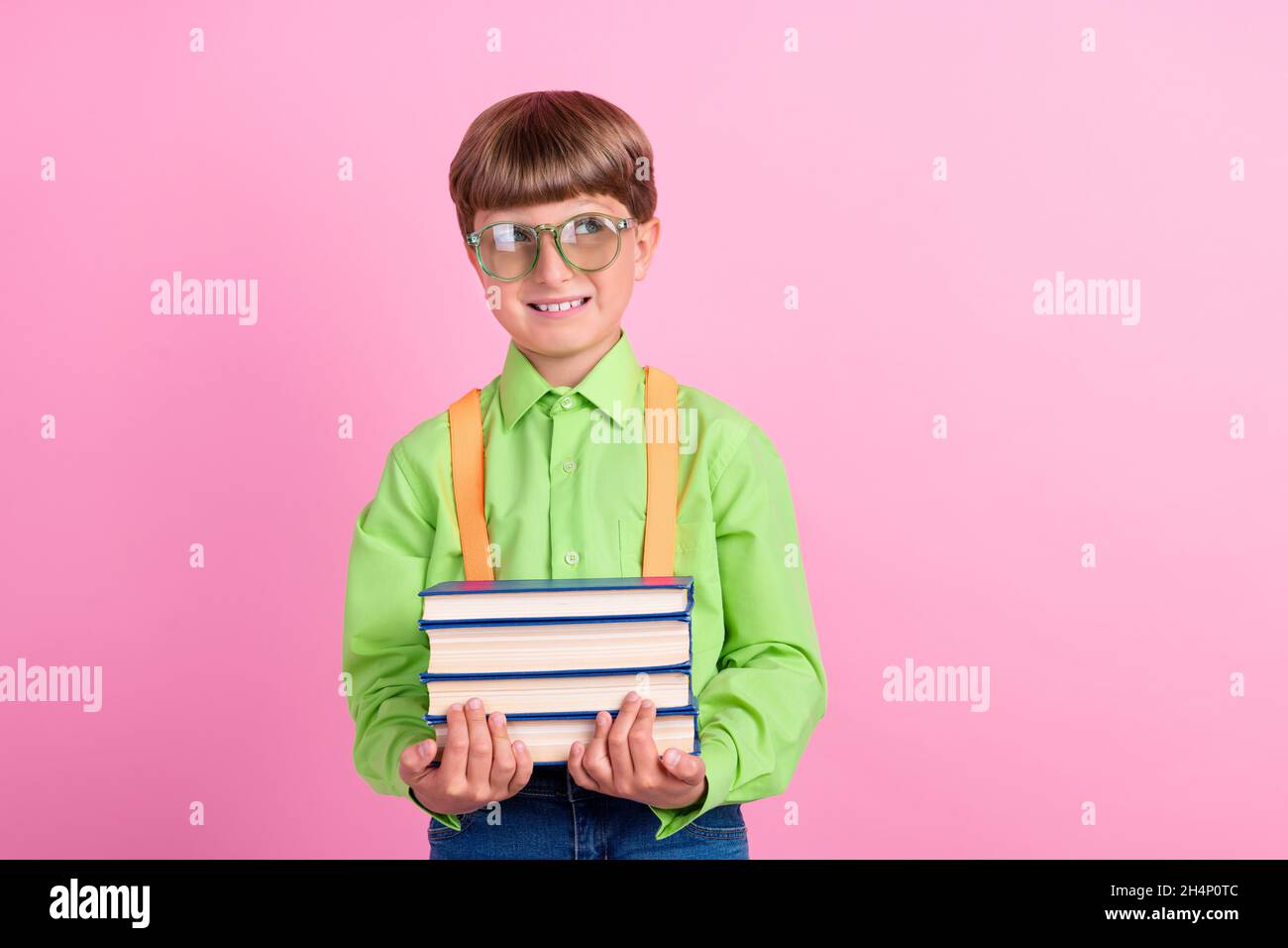 Photo of young small school boy book lesson stack materials education ...
