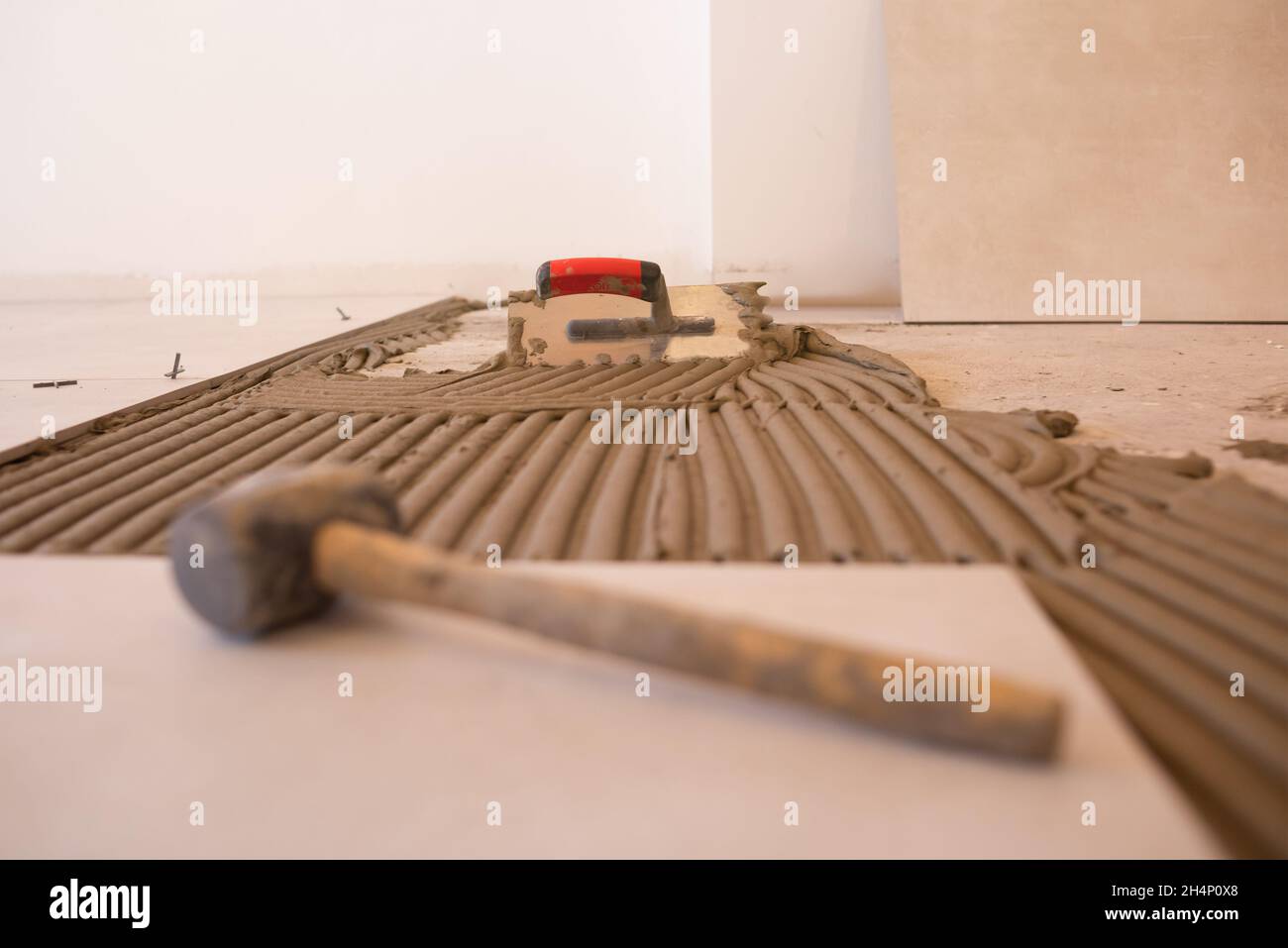 Ceramic large tiles and tools for tiler on the floor unfinished laying ...