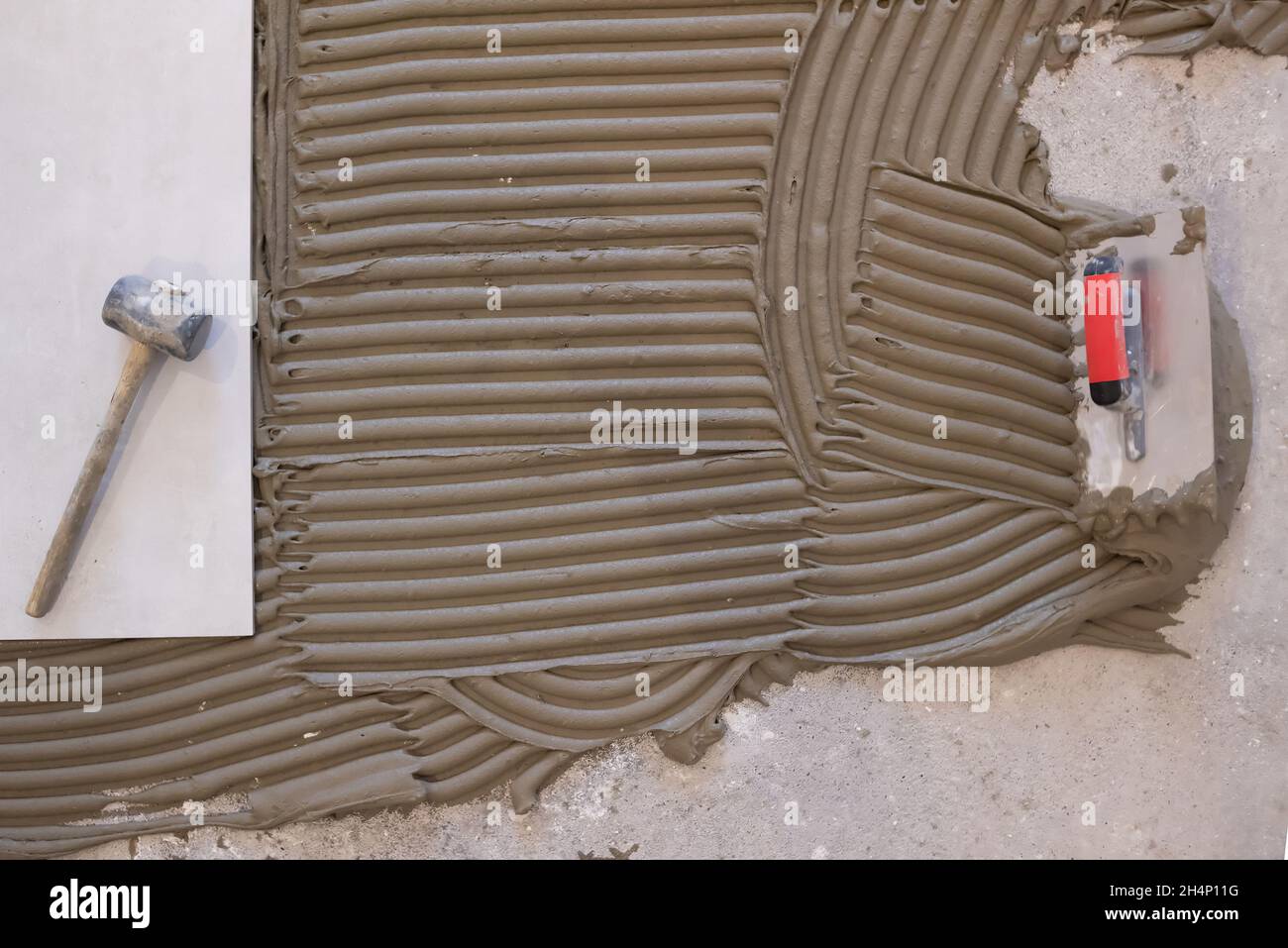 Ceramic large tiles and tools for tiler on the floor unfinished laying ...