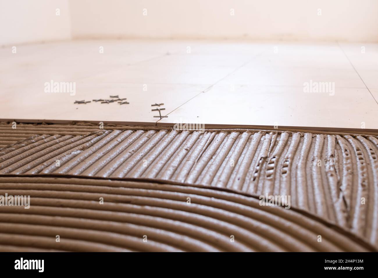 Ceramic large tiles and tools for tiler on the floor unfinished laying ...