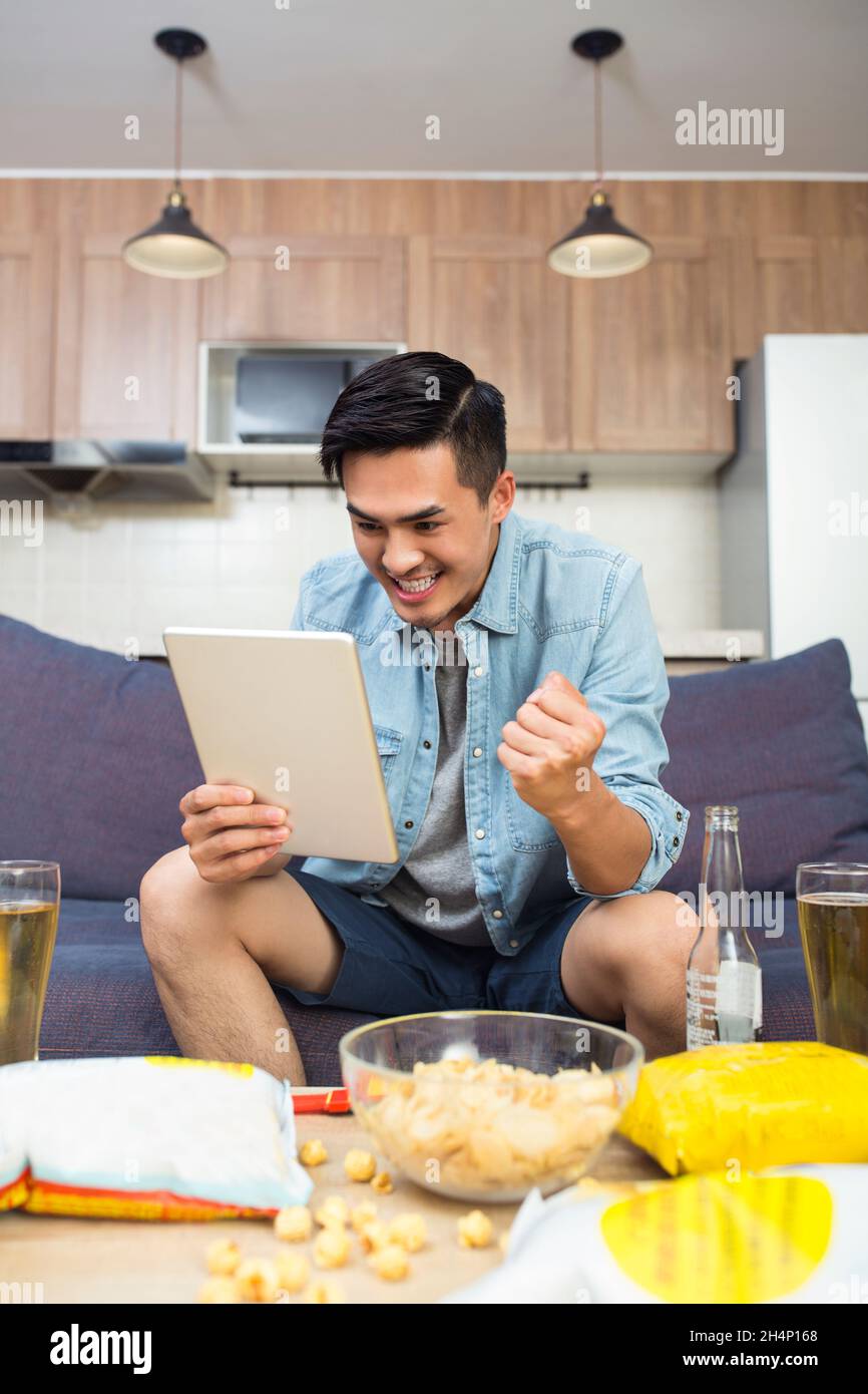 Soccer watching tablet room hi-res stock photography and images - Alamy