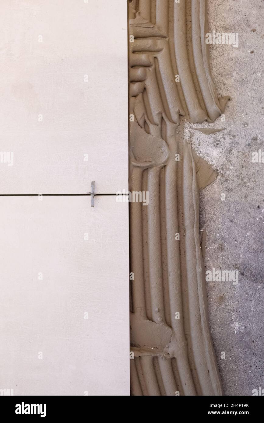 Ceramic large tiles and tools for tiler on the floor unfinished laying ...