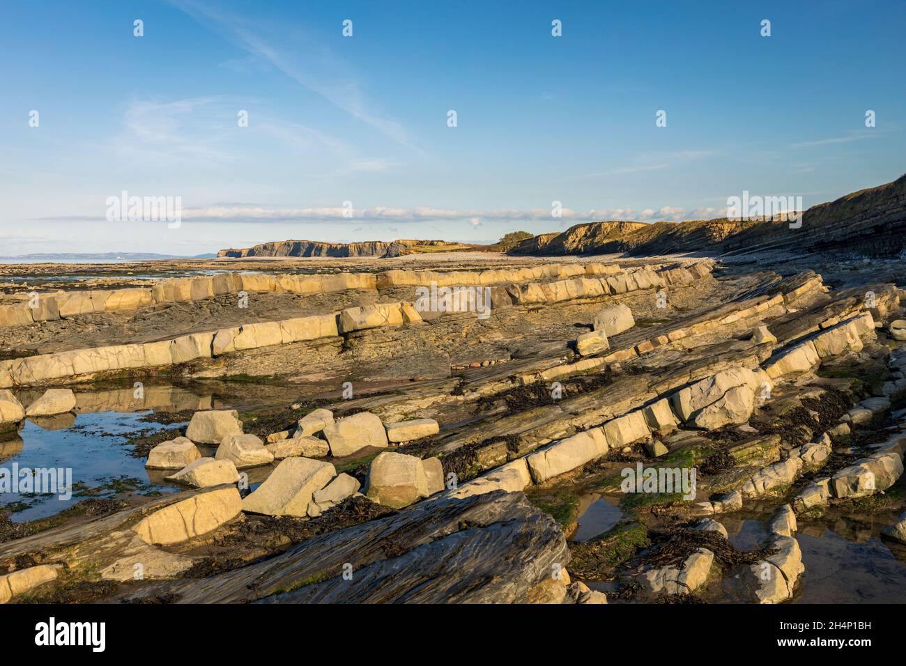 Sunny October afternoon and low tide along the rocky Kilve Beach in ...