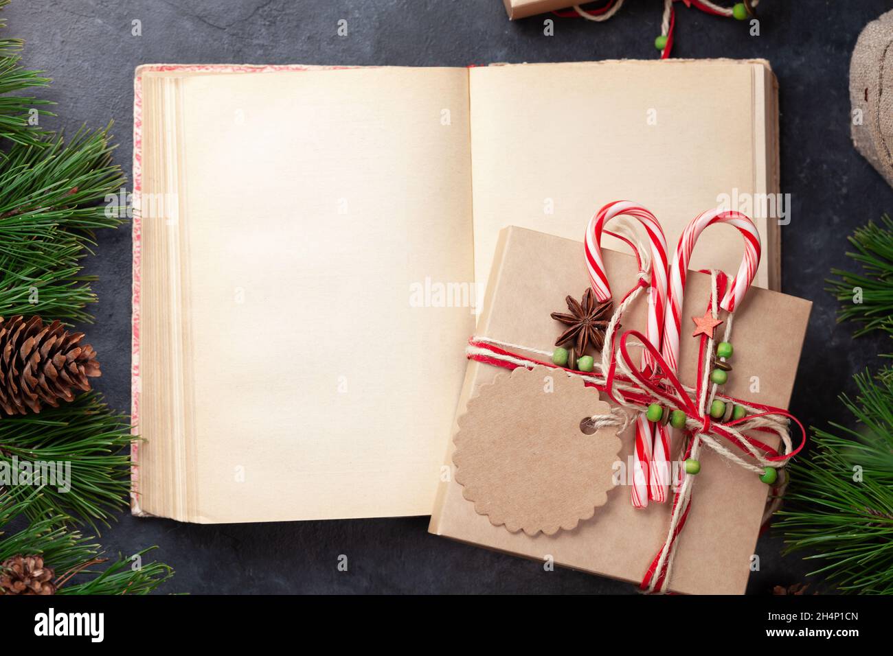 Christmas gift box with craft decor and vintage book. Top view flat lay ...