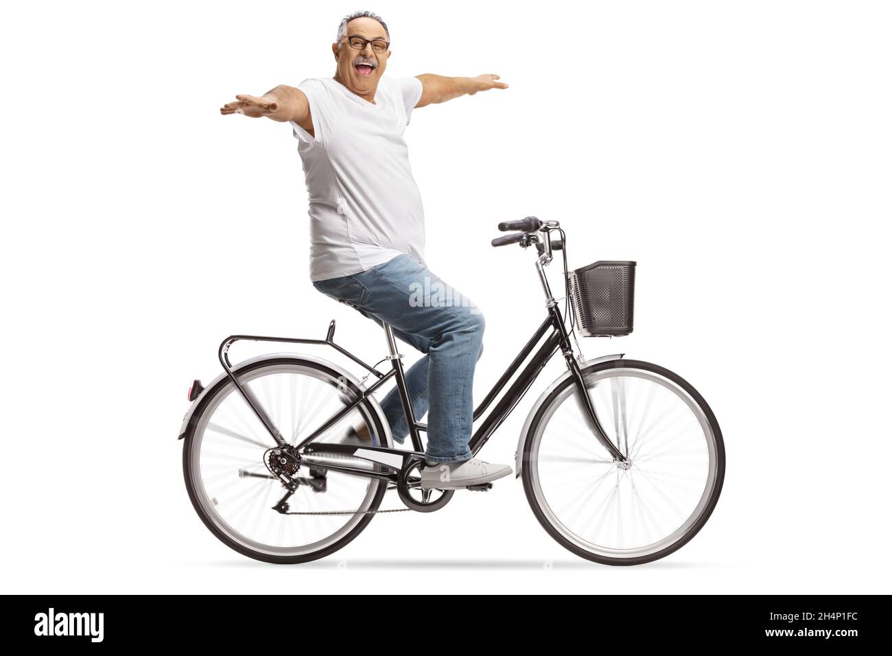 Happy mature man riding bicycle with arms wide open isolated on white ...