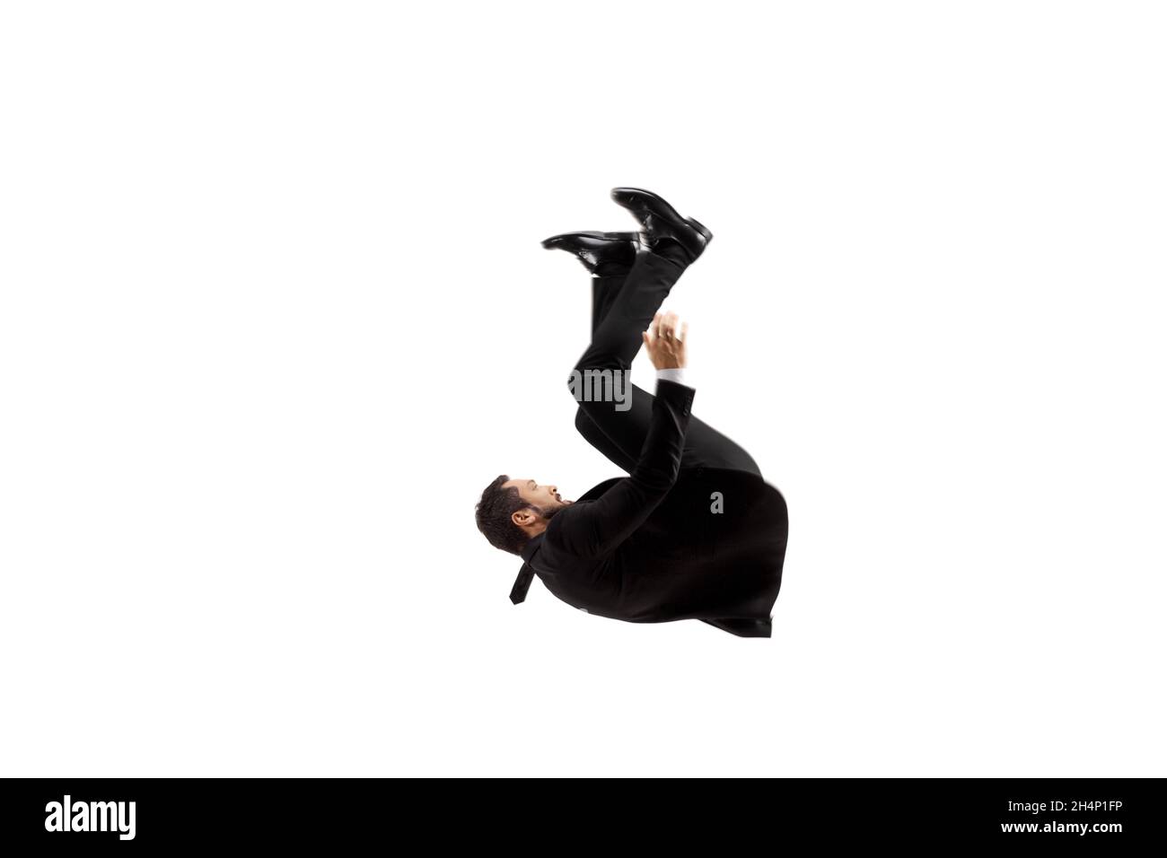 Man in a black suit falling on the ground isolated on white background ...