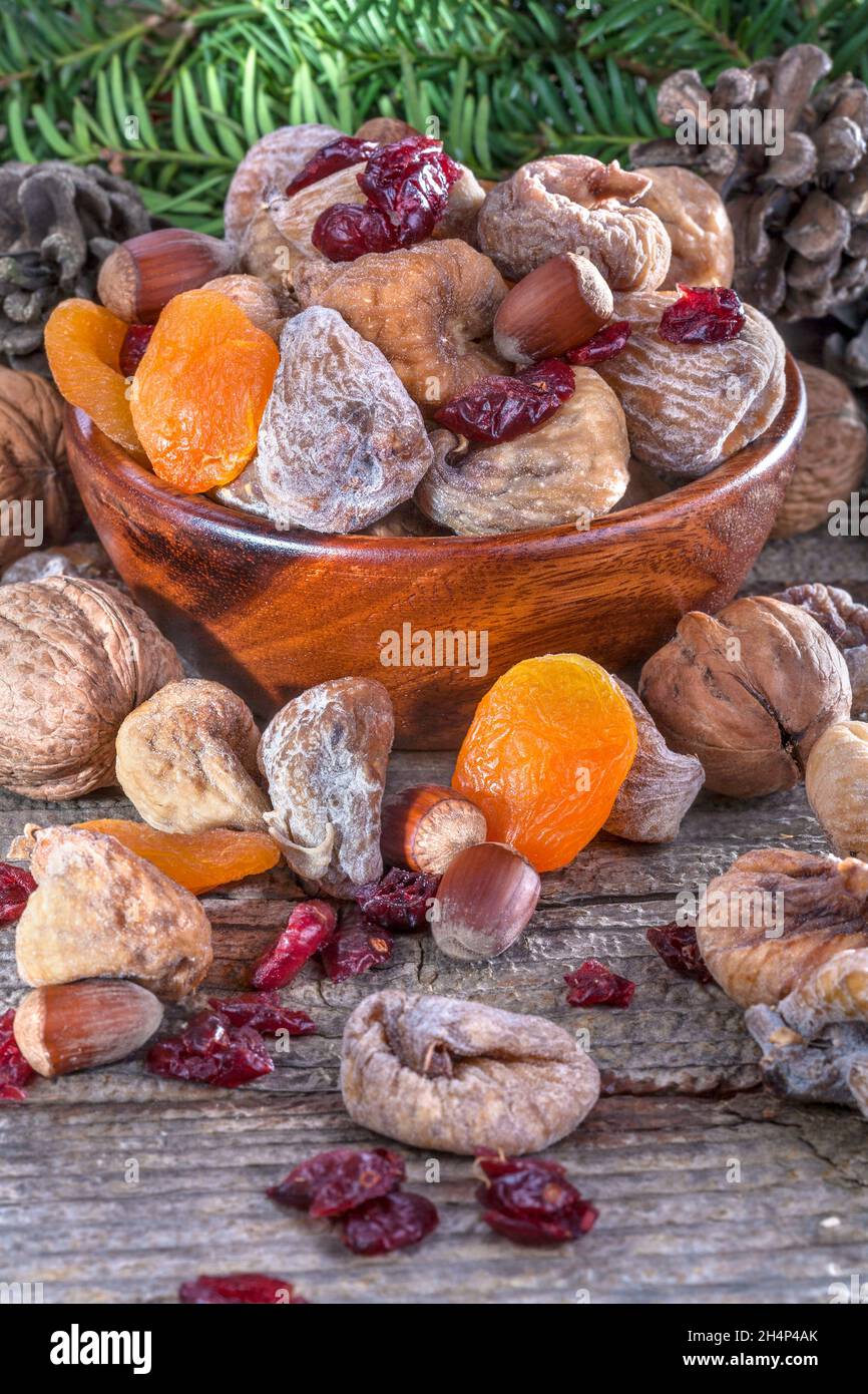 Dried fruits with walnuts and hazelnuts in a wooden bowl Stock Photo ...