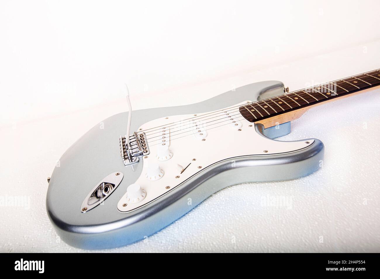 Silver electric guitar isolated on white background Stock Photo - Alamy