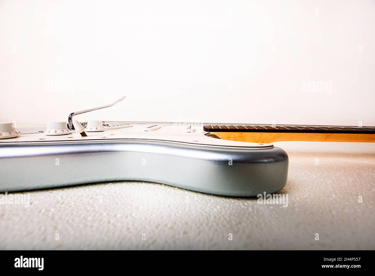 Silver electric guitar isolated on white background Stock Photo - Alamy