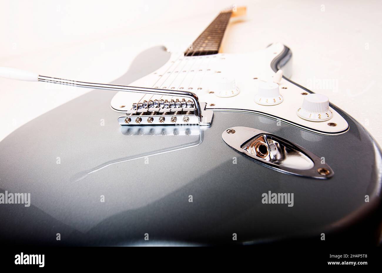 Silver electric guitar isolated on white background Stock Photo - Alamy