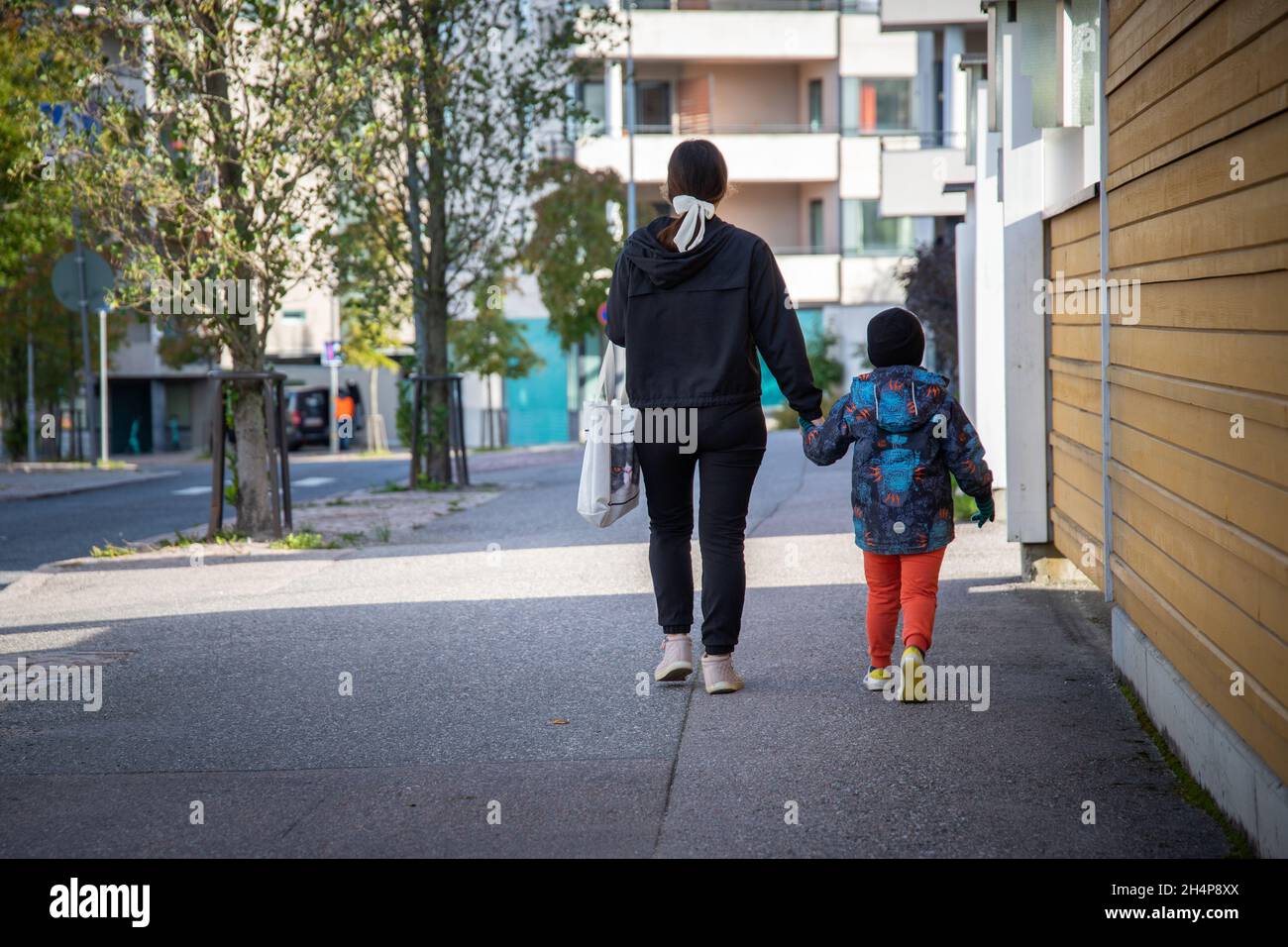 Woman child walking back view town hi-res stock photography and images ...