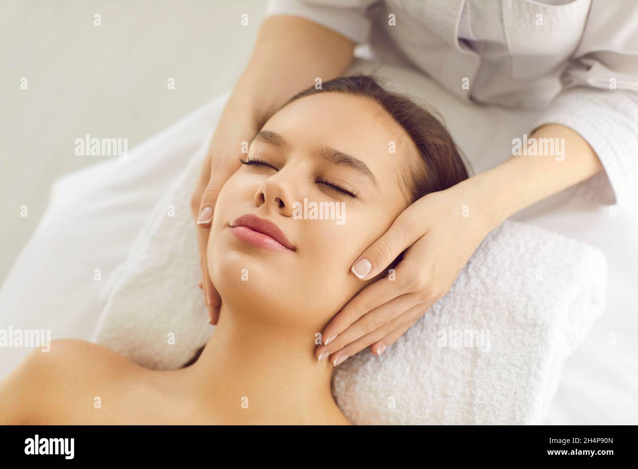 Woman getting face massage and cosmetic facial treatment for clean ...