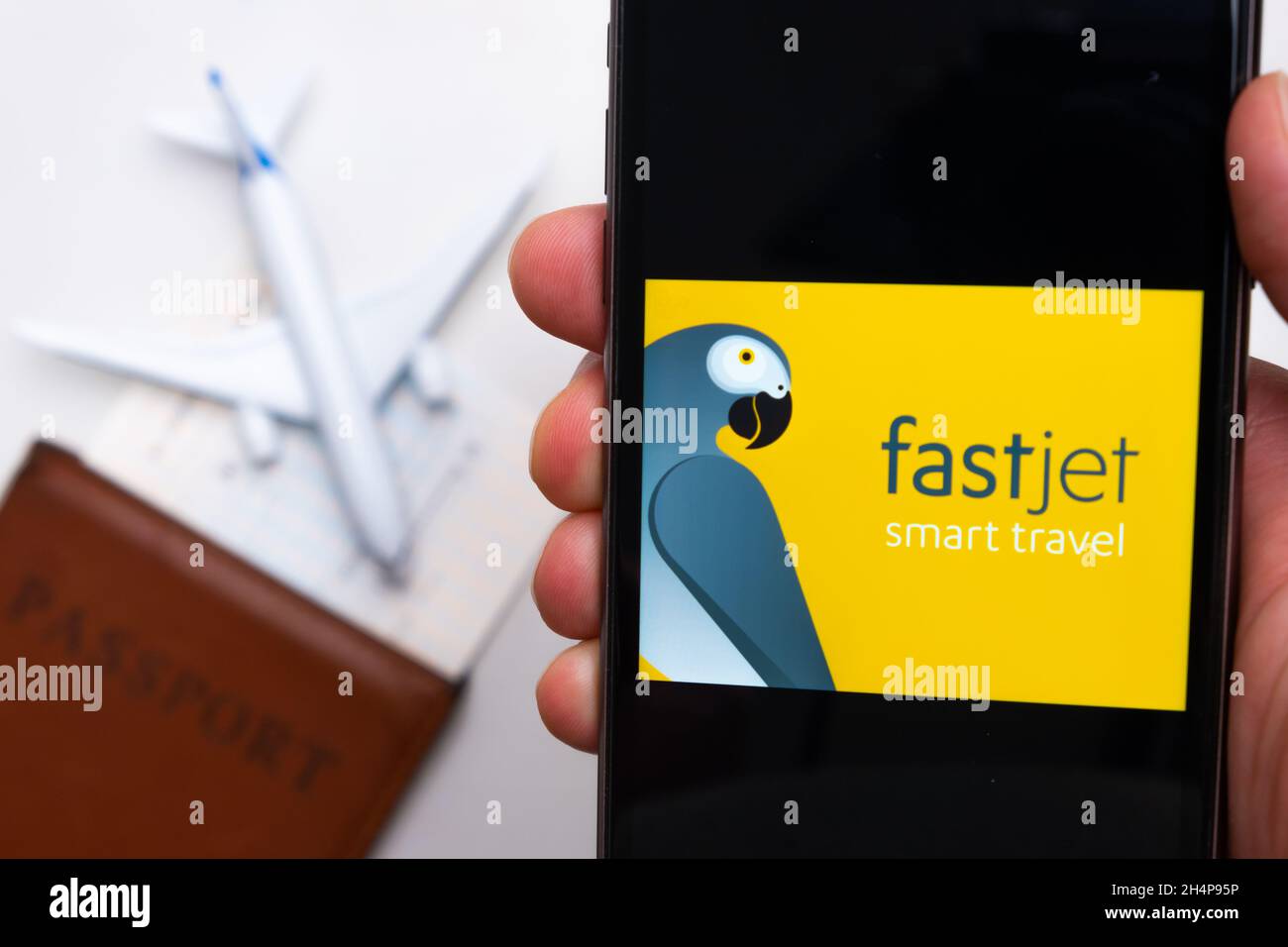 Fastjet airlines company logo on the screen of mobile phone in man hand on the background of ...