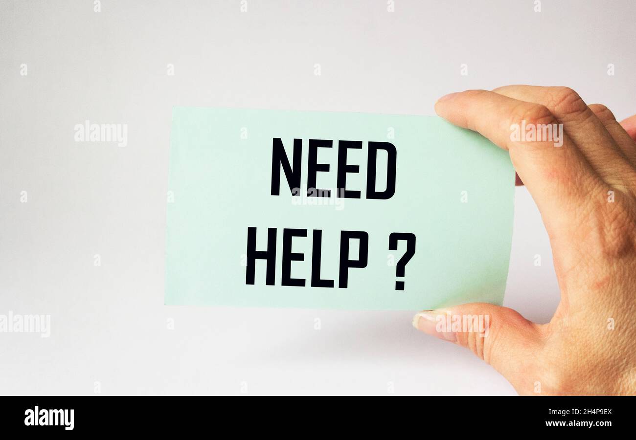 Sticker with text NEED HELP holds a female hand on a light background ...