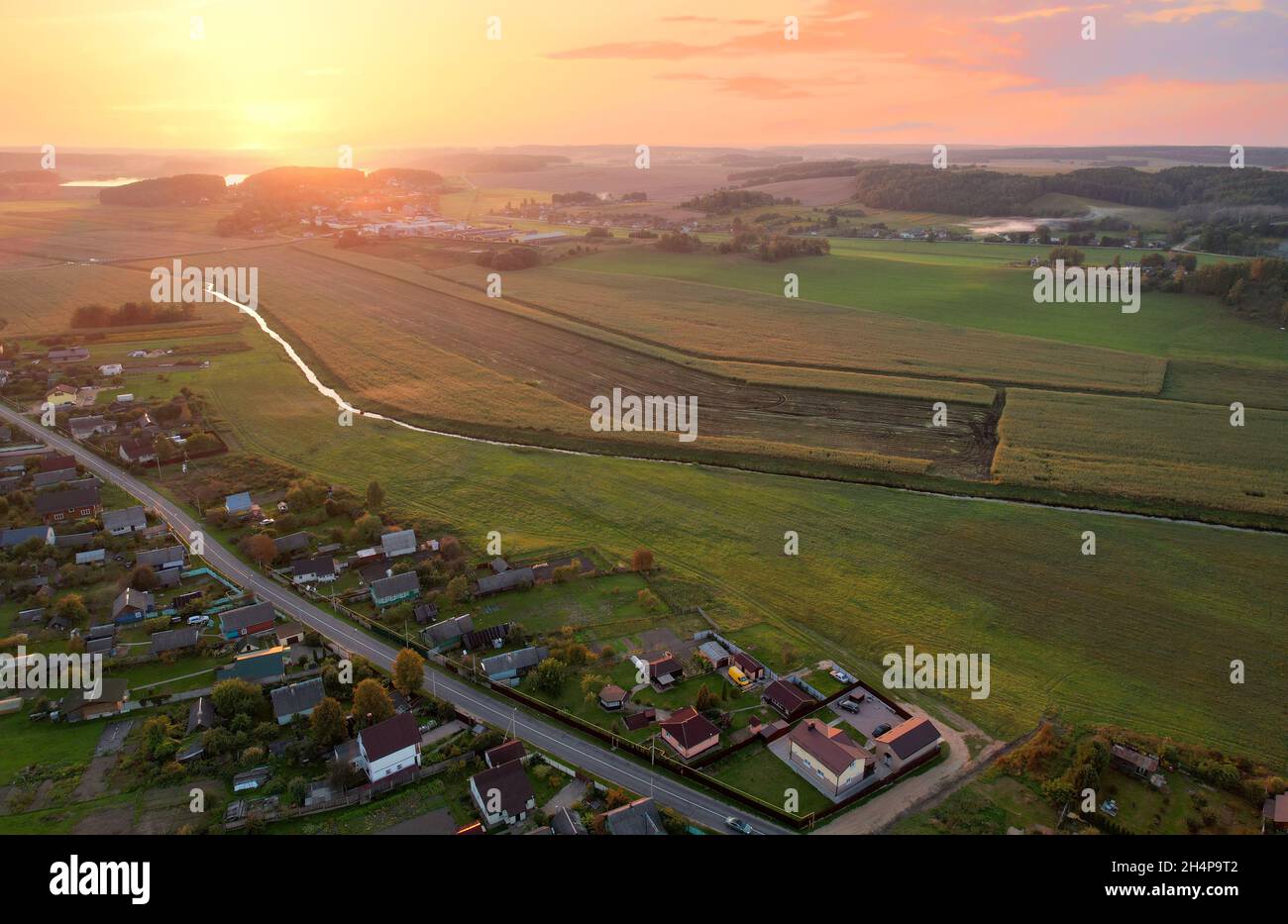 Country houses in the countryside. Aerial view of roofs of green field ...