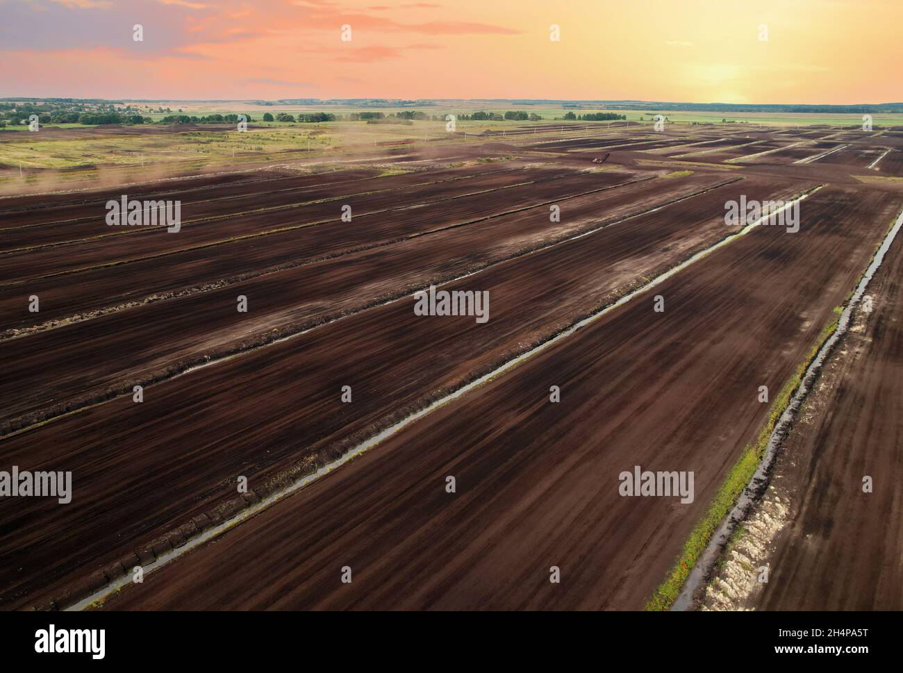 Peat extraction site. Harvester at collecting peat on peatlands. Mining ...