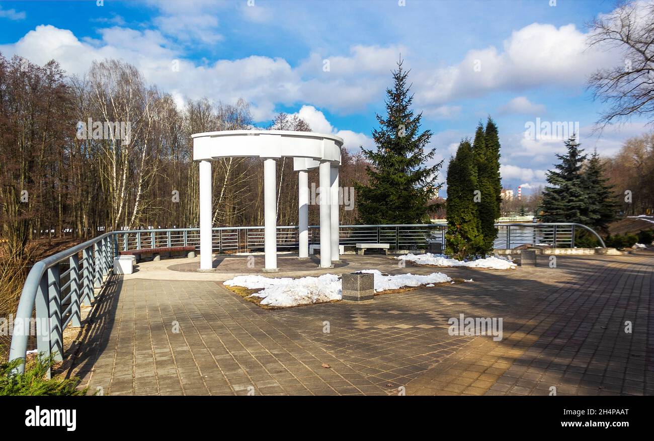 White columns in the form of a rotunda on the shore of a reservoir in ...