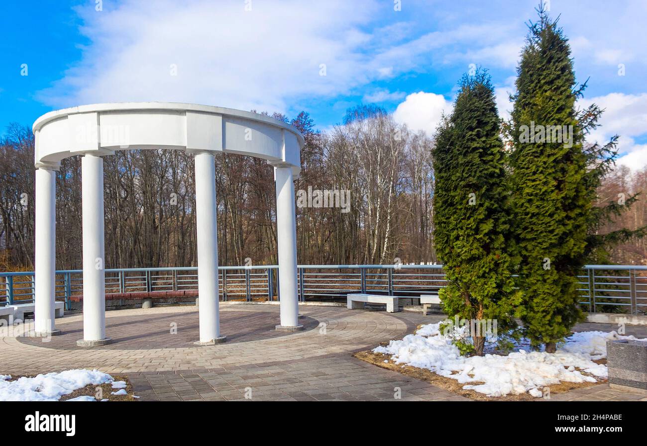 White columns in the form of a rotunda on the shore of a reservoir in ...