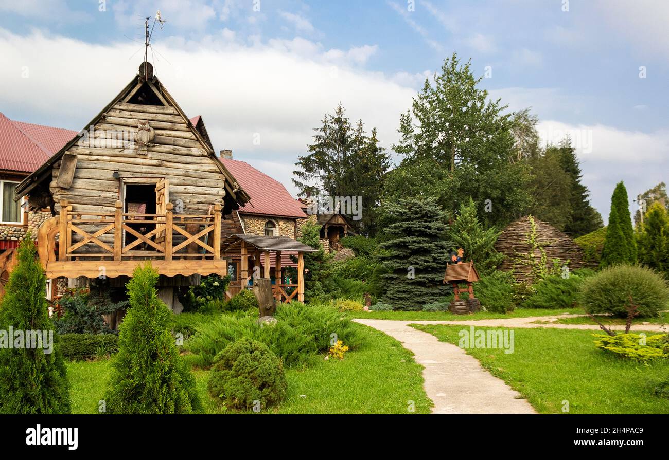 Beautiful rustic wooden house with carvings in the summer heat, in a ...