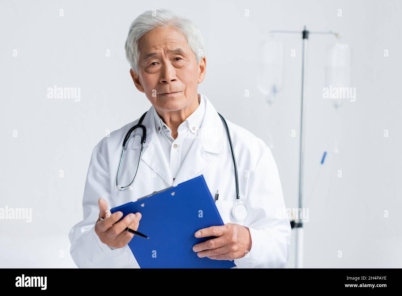 Asian doctor looking clipboard hi-res stock photography and images - Alamy