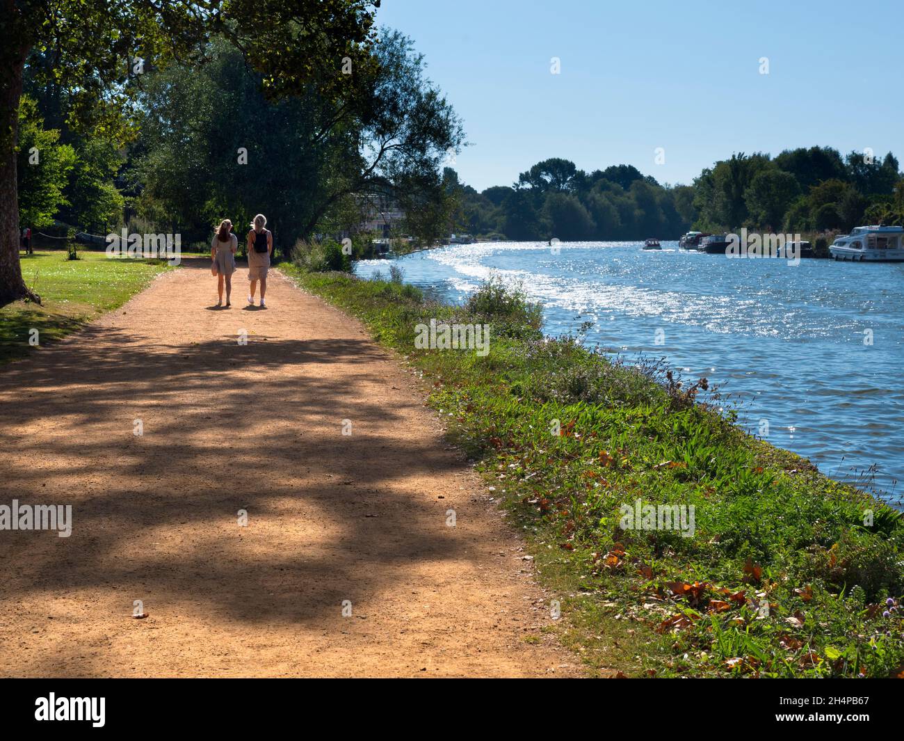Walkers on the Thames path, which runs by the river just downstream of ...