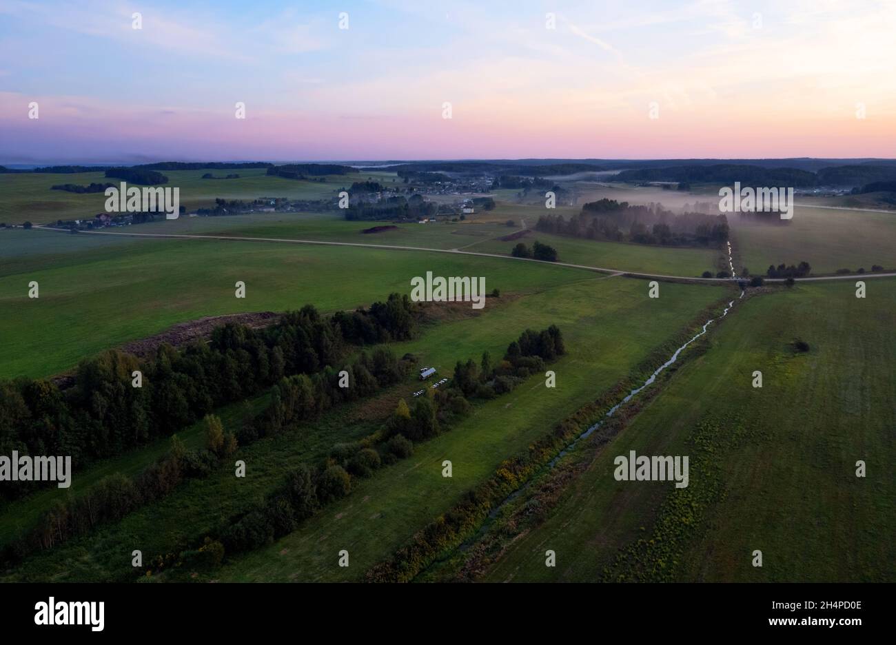 Country houses in the countryside. Aerial view of roofs of green field ...