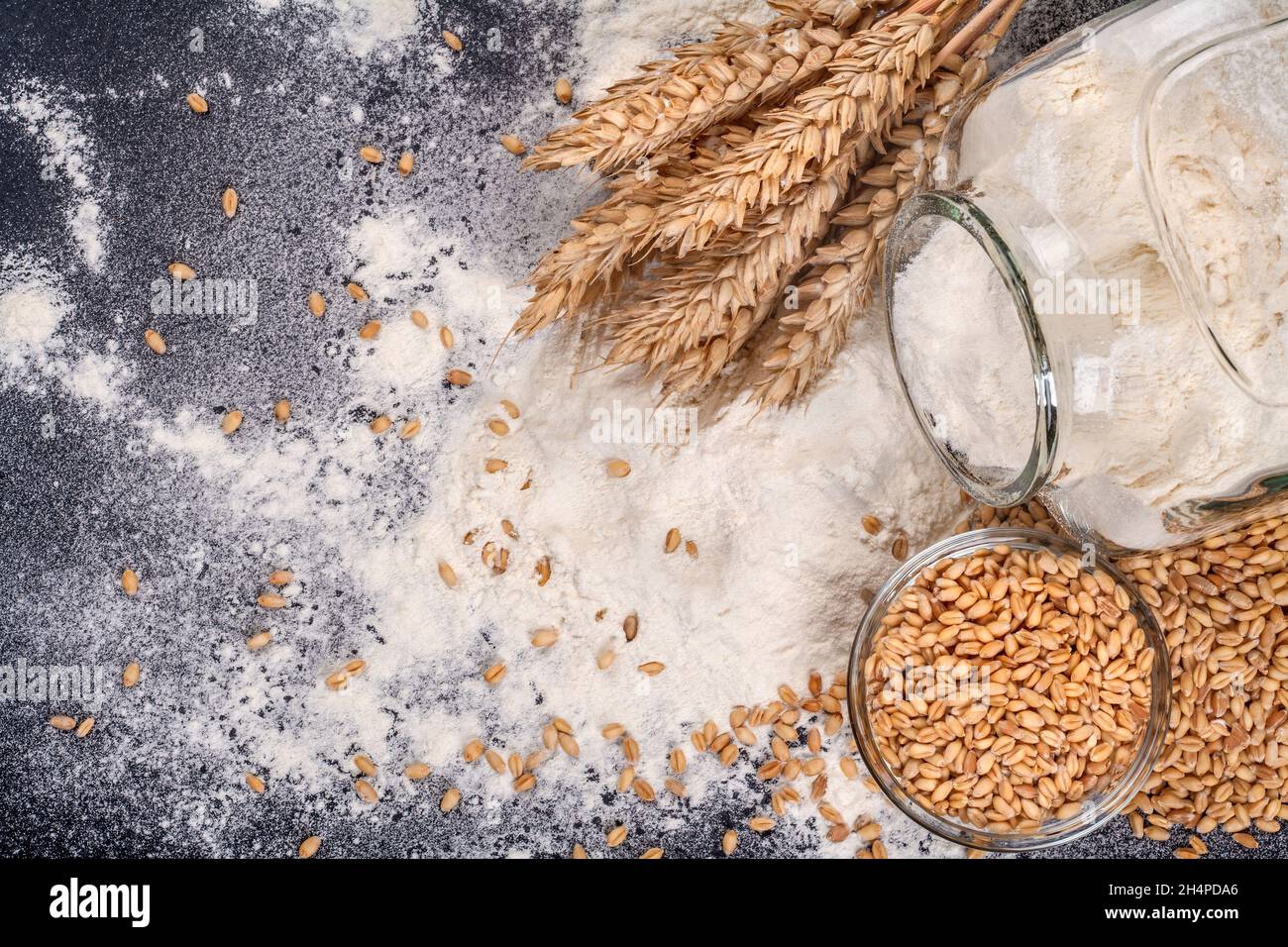 organic flour with grain on black background Stock Photo - Alamy