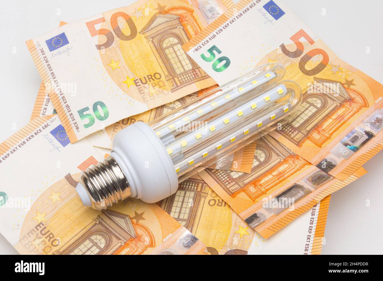 Banknotes and light bulbs on top of the money Stock Photo - Alamy