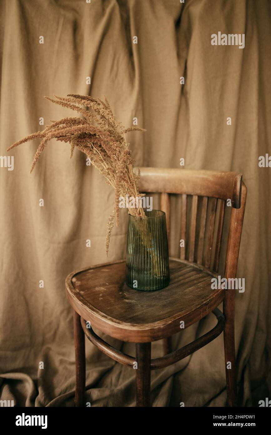 Ceramic brown jug with a bunch of ears of corn. Picture of a rural life ...