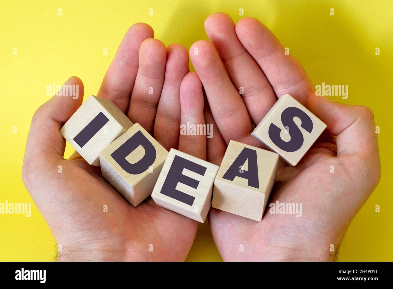 hand holding Wooden with text idea on white background Stock Photo - Alamy