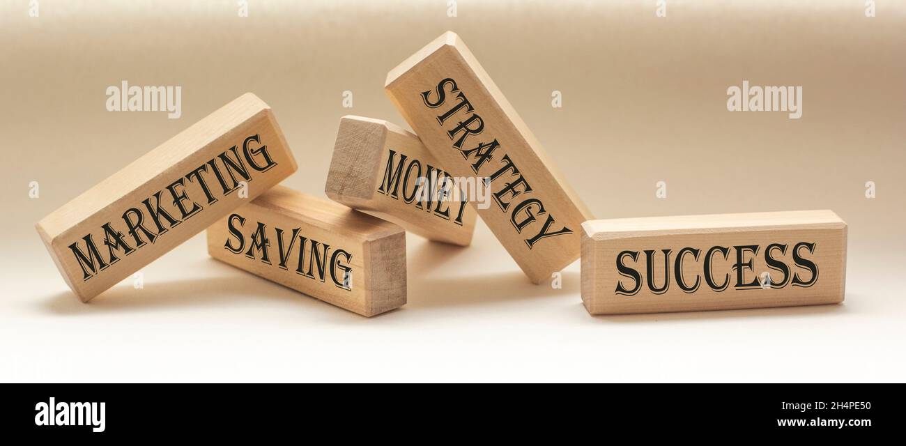 Wooden blocks with text: strategy, marketing, money, saving, success ...