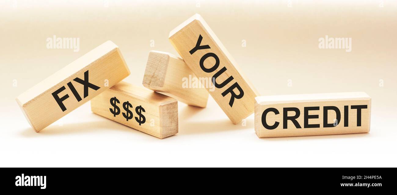 Fix Your Credit text is written on building blocks and light background ...