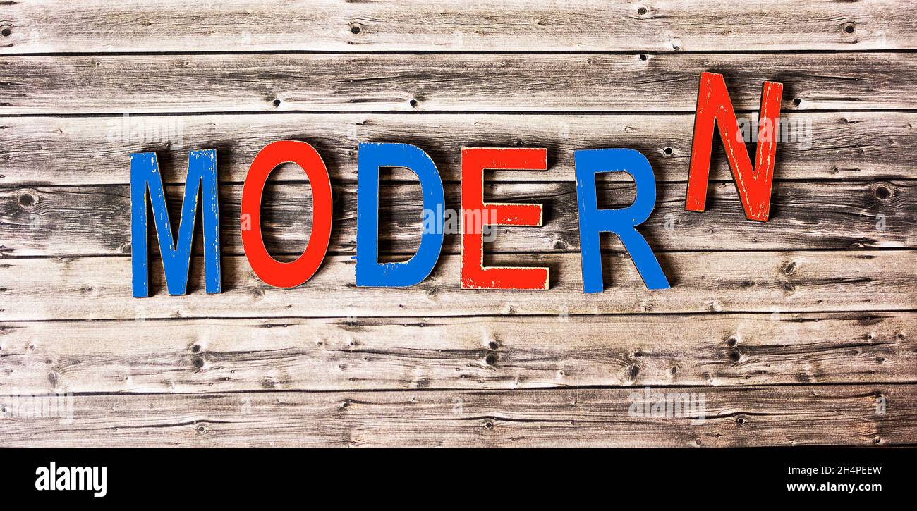 The word MODERN is composed of multicolored letters on a wooden ...