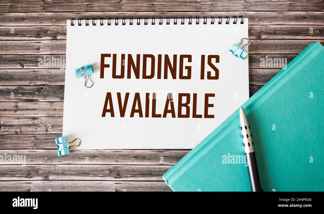 Financing Available, Text on Notepad and Wooden Table Sponsored ...
