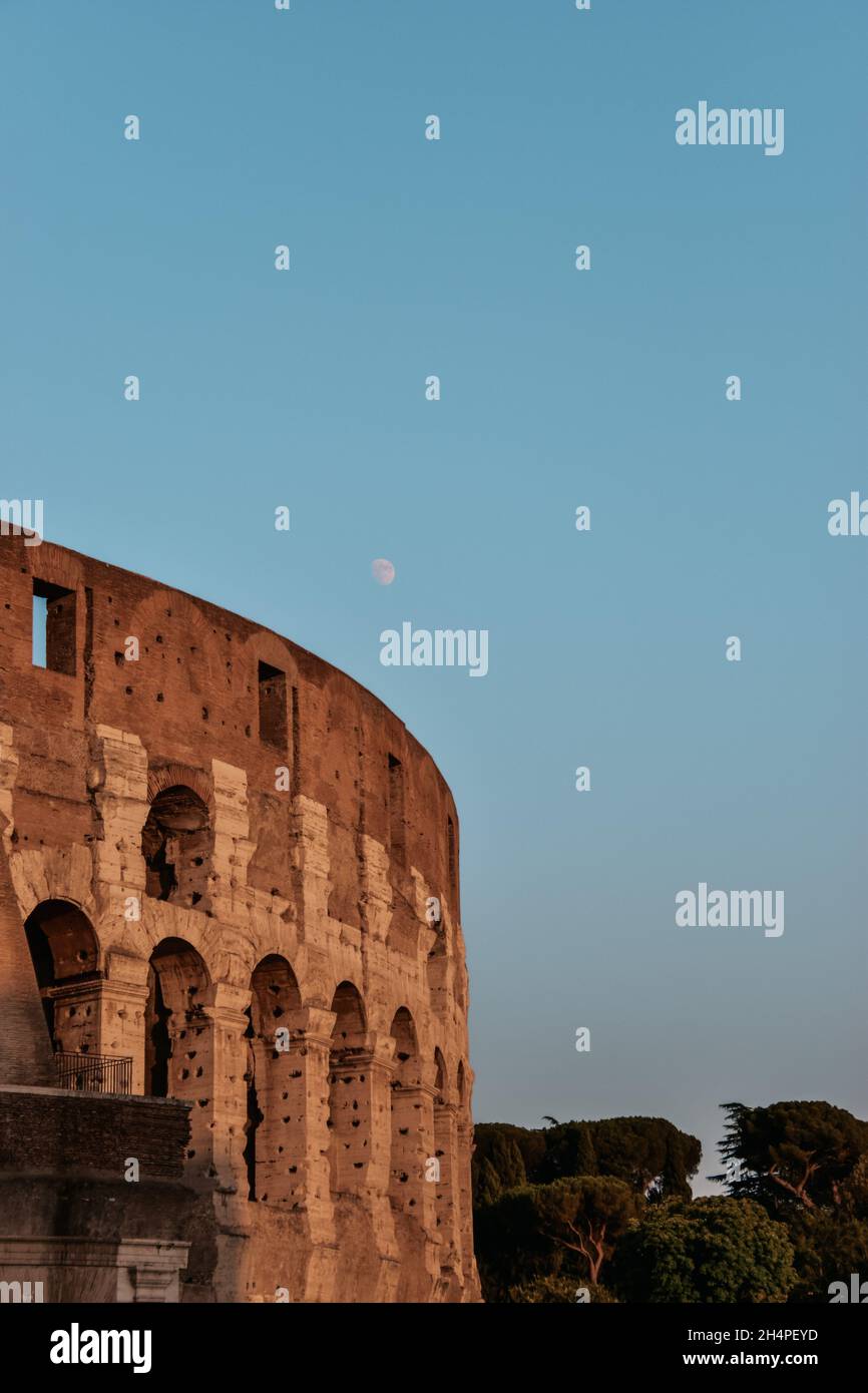 Beautiful scenery of the circular Colosseum, Rome, Italy under a blue ...