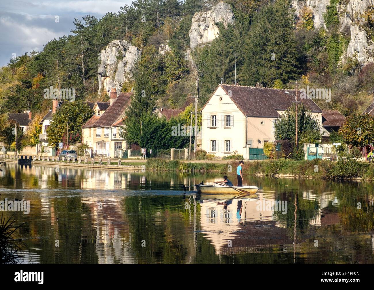 It is early morning and two boys are crossing the River Yonne at Merry ...