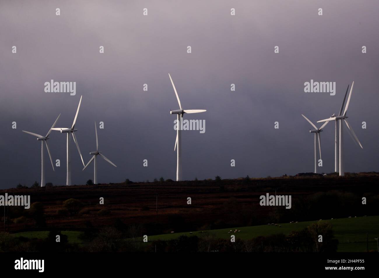 Wind turbines on farmland in Co. Derry, Northern Ireland. To reduce ...